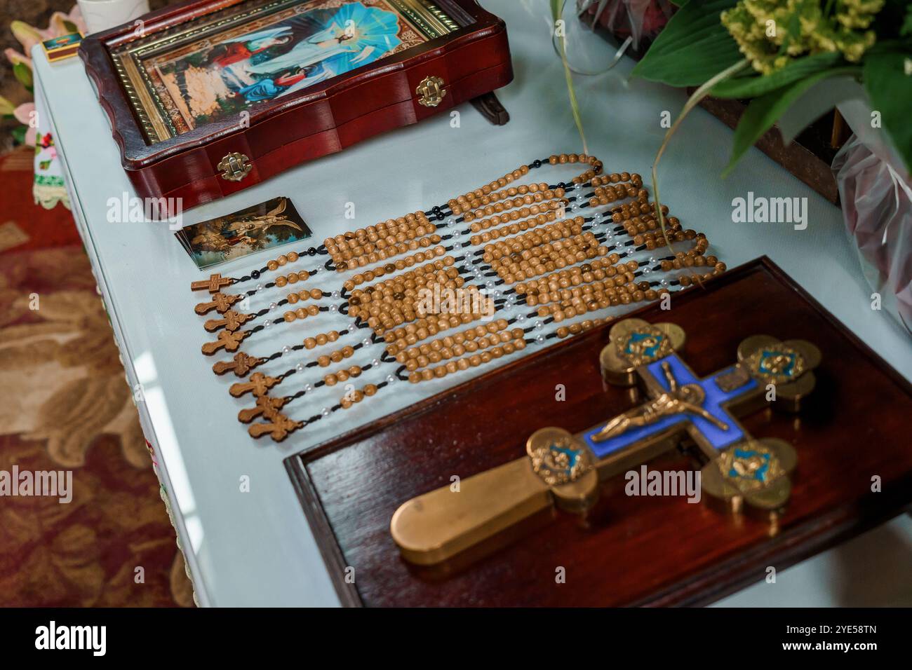 Religious Artifacts Displayed on a Table with Rosaries, Crosses, and ...