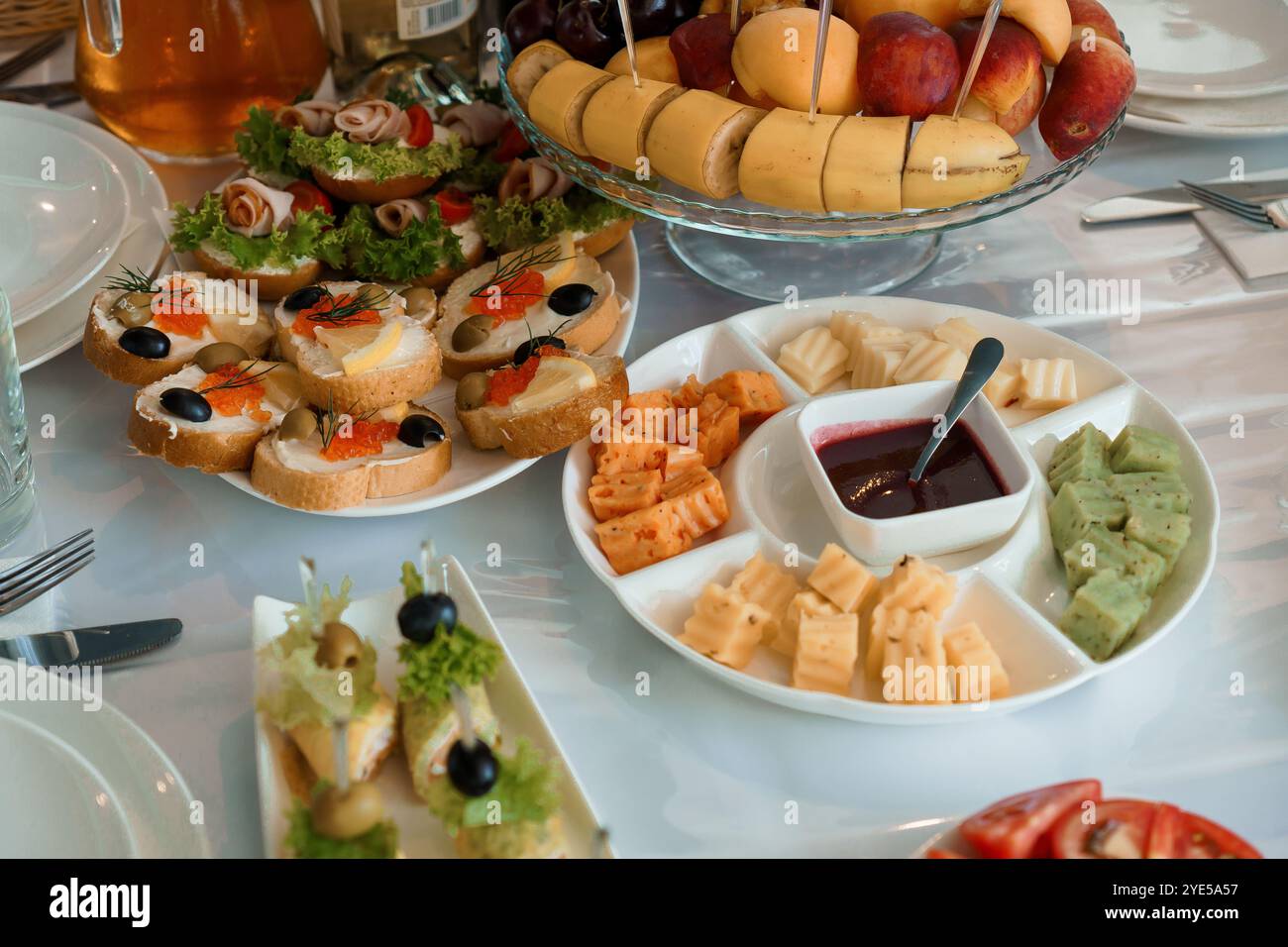 Elegant Table Spread Featuring Assorted Appetizers, Fruits, and Cheeses Stock Photo - Alamy