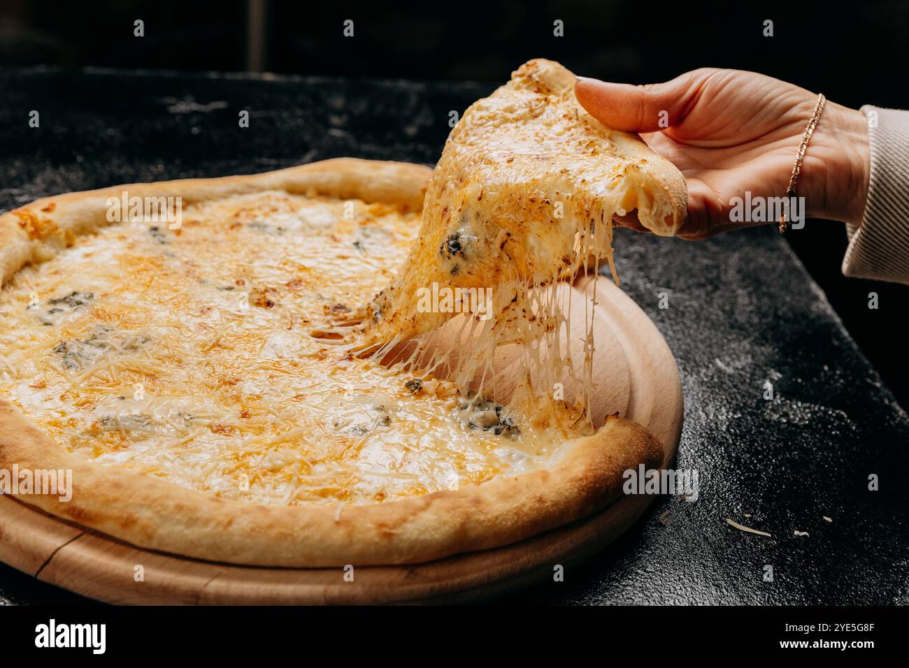 Melting cheesy pizza slice being lifted, showcasing gooey cheese pull ...