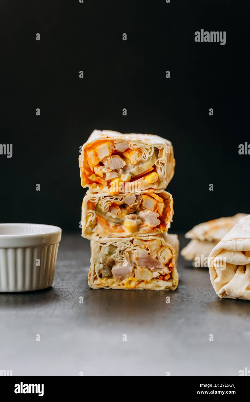 Stacked chicken wraps with vibrant fillings, perfect for takeaway or ...