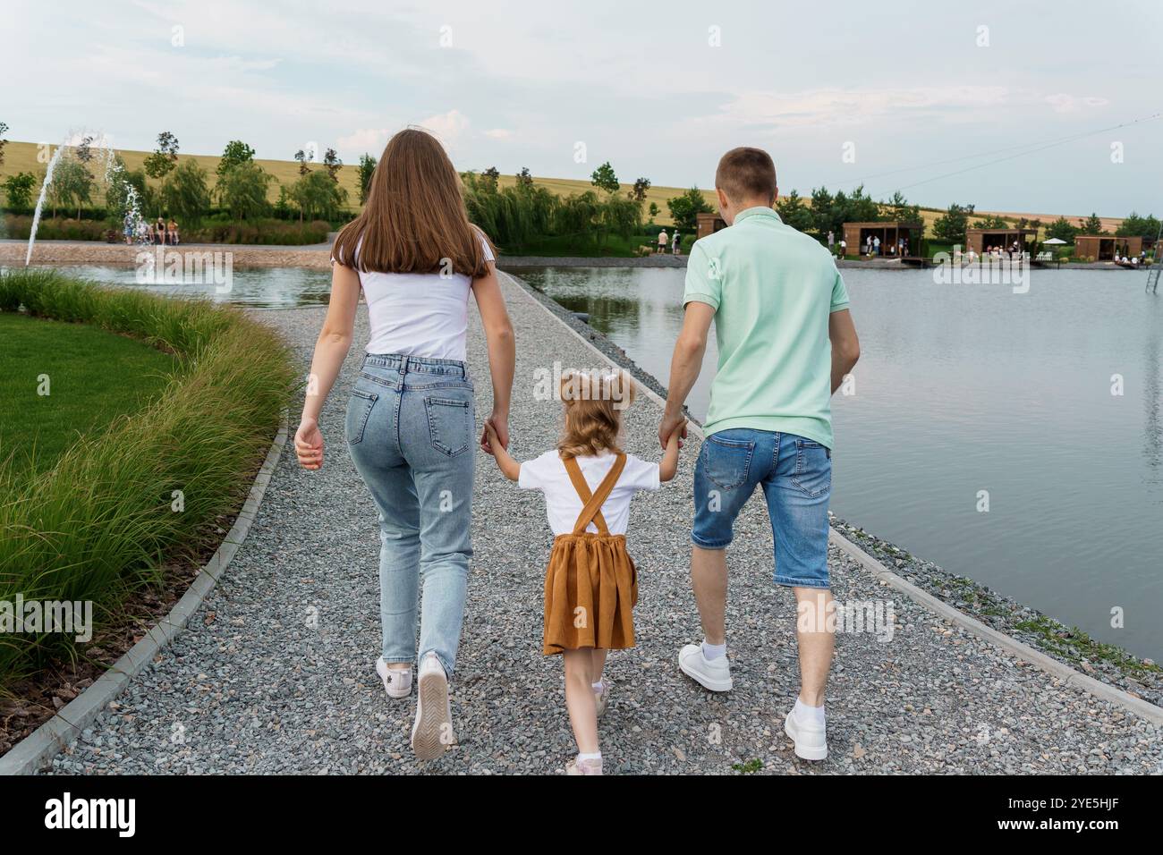 A Family Stroll by the Scenic Lake in the Park Stock Photo - Alamy