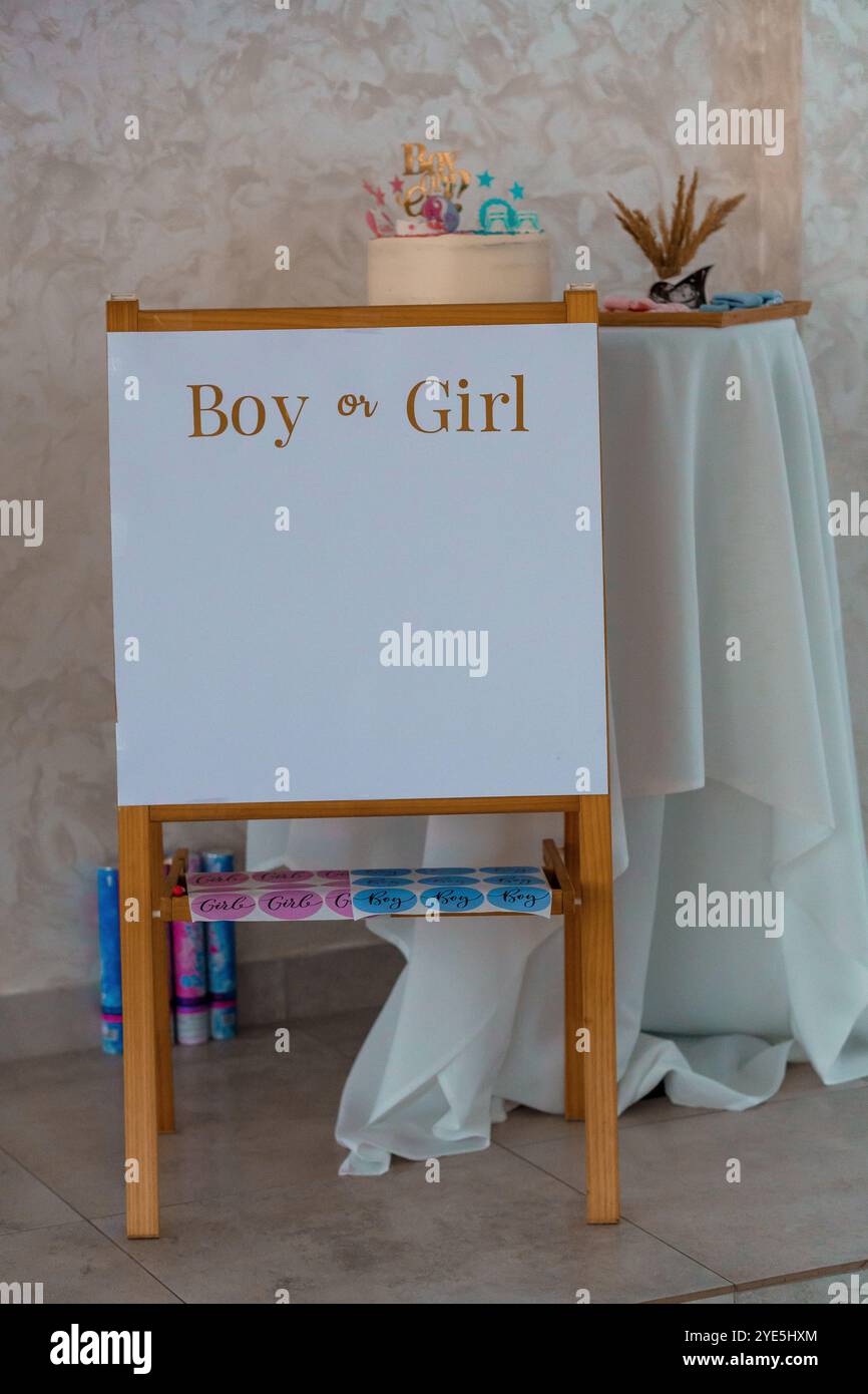Creative Gender Reveal Setup with Chalkboard Sign and Cake Stock Photo ...
