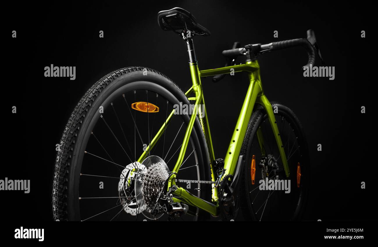 Rear view of a green gravel bike with modern design, set against a ...