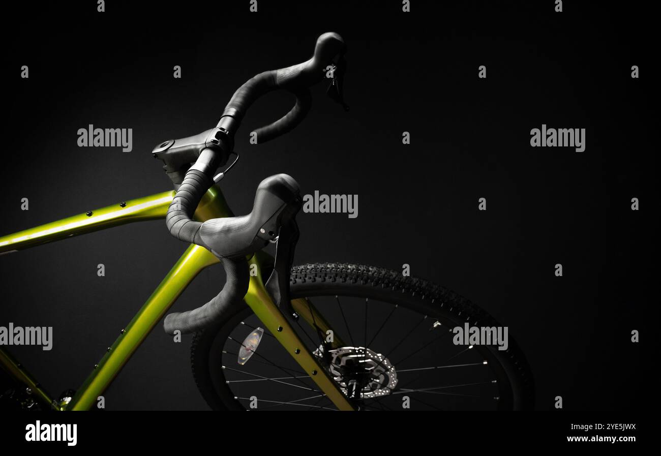 Gravel green bike with a metallic sheen, shot against a dark background ...