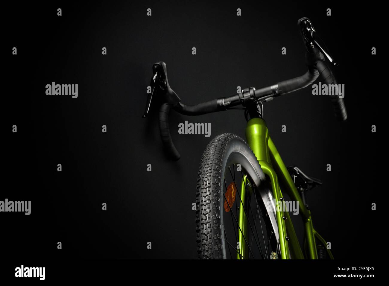 Gravel green bicycle, shot from the bottom of the front wheel. Black ...