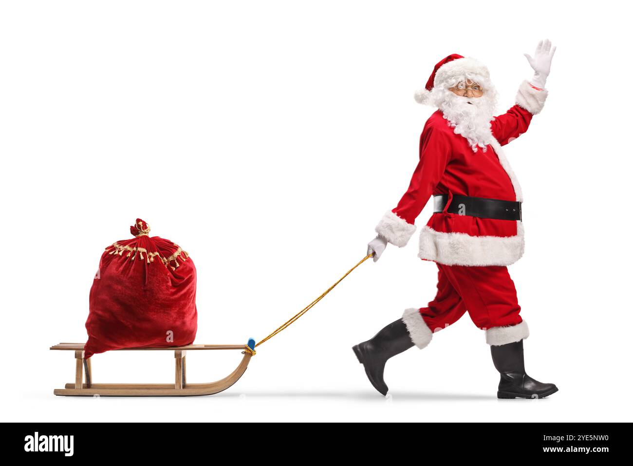 Santa Claus pulling a wooden sled with a sack and waving isolated on ...