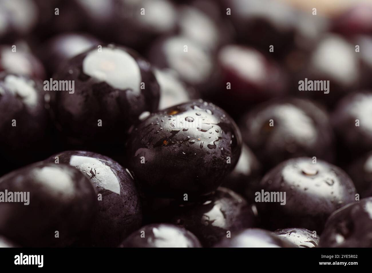 Wet acai berries as background, closeup view Stock Photo - Alamy