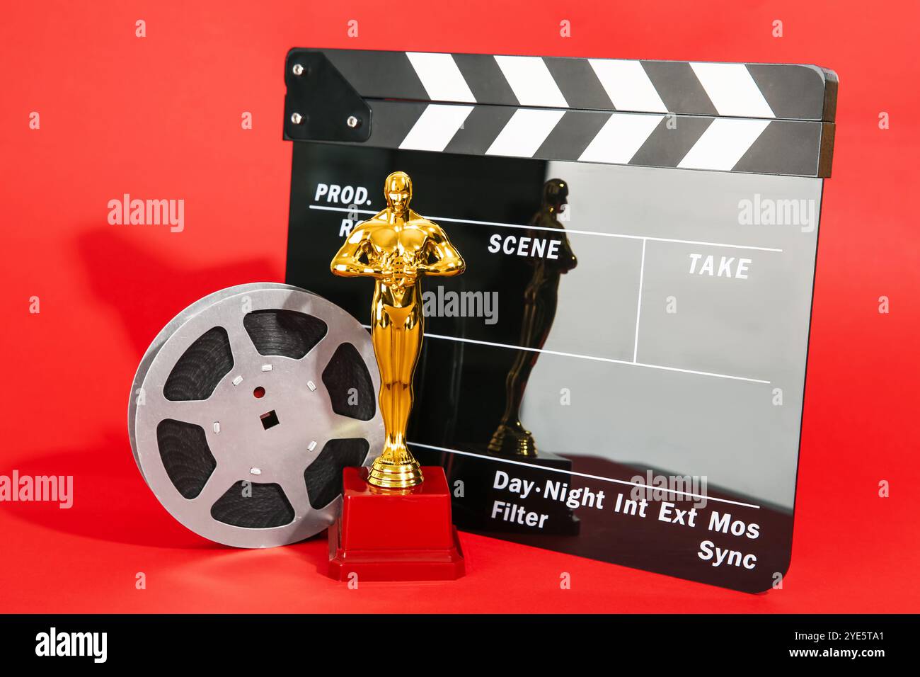Golden trophy in shape of human figure, movie clapper and film reel on ...