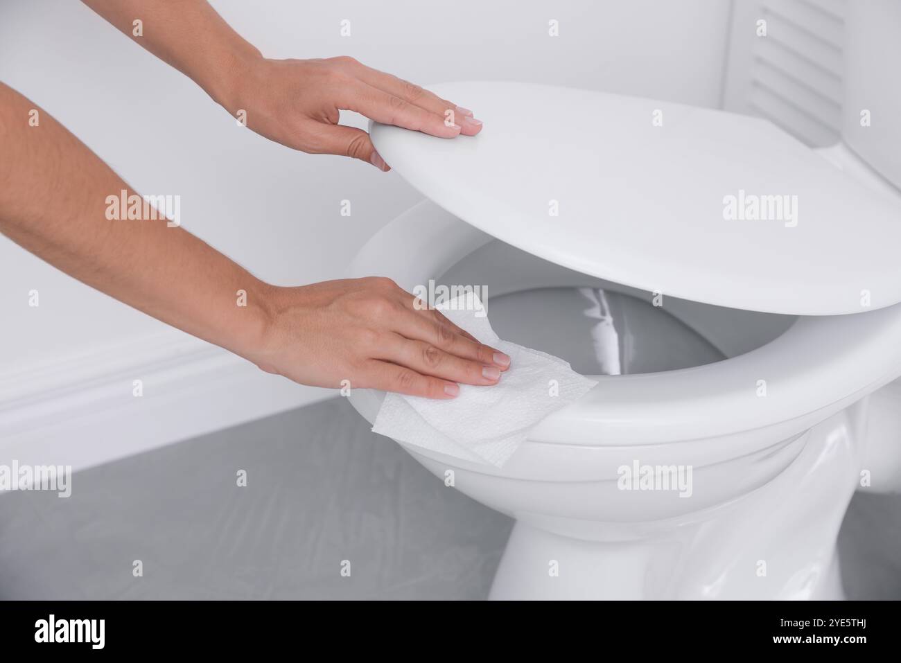 Woman wiping toilet seat hi-res stock photography and images - Alamy