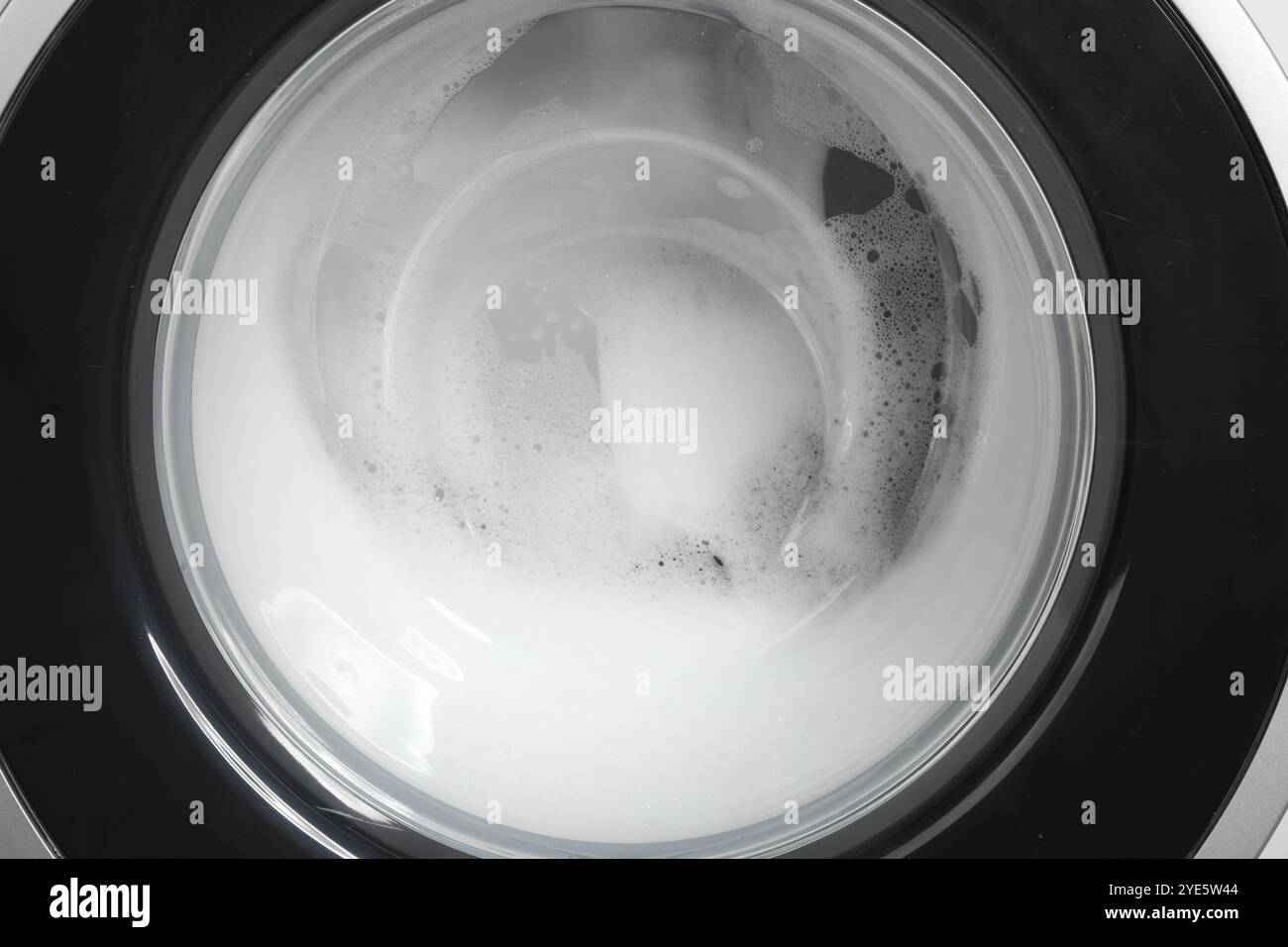 Washing machine with suds as background, closeup Stock Photo - Alamy