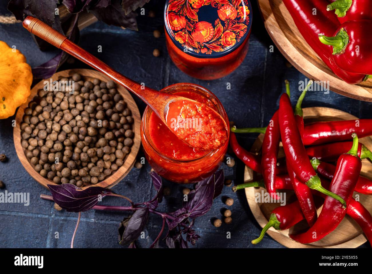 Wooden spoon scooping homemade chili sauce from open jar Stock Photo ...