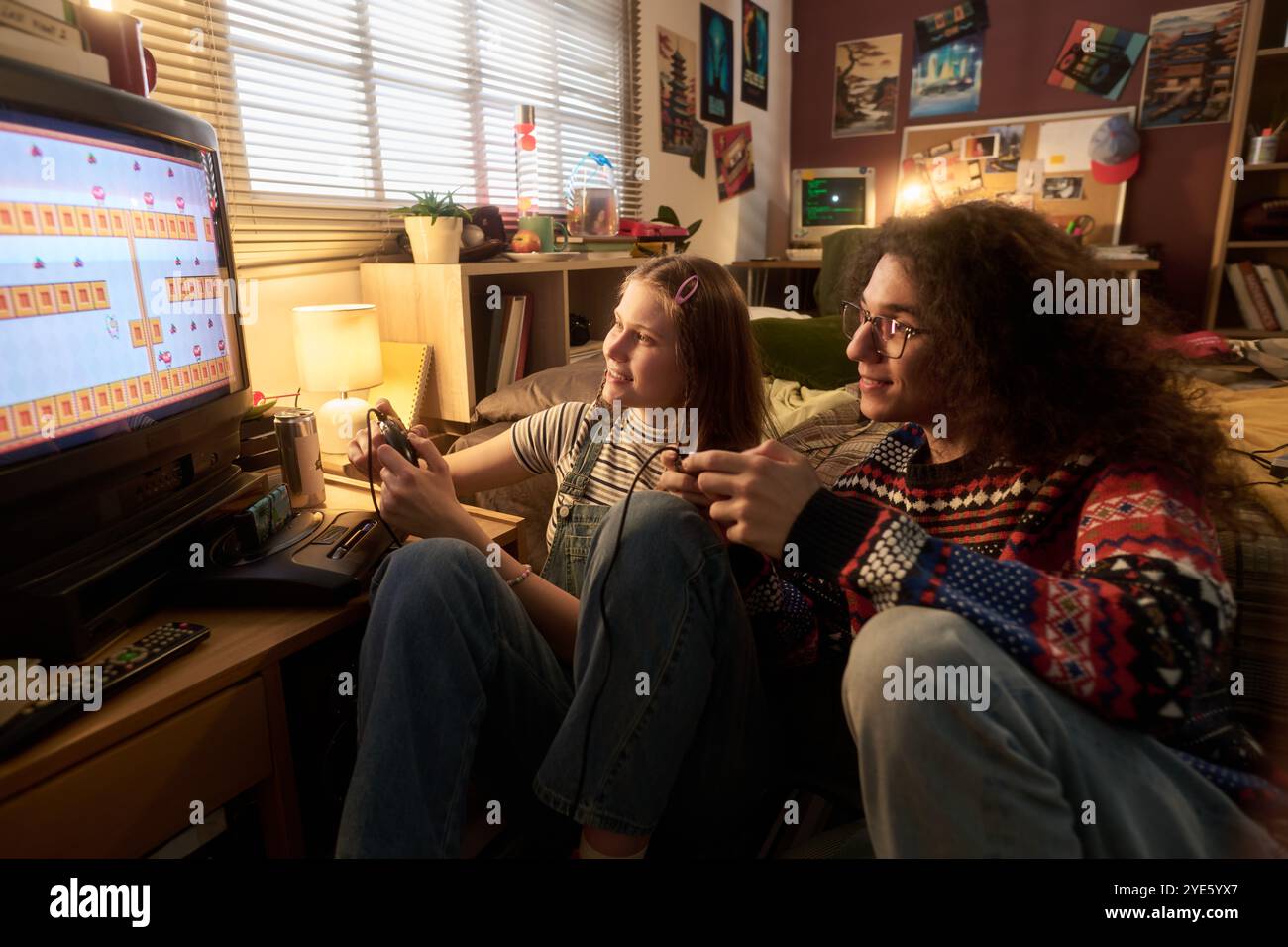 Two friends playing video games in a cozy, well-decorated bedroom with ...