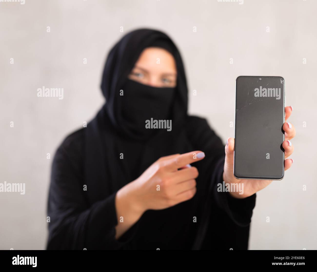 Young woman dressed in traditional islamic clothes with her face ...