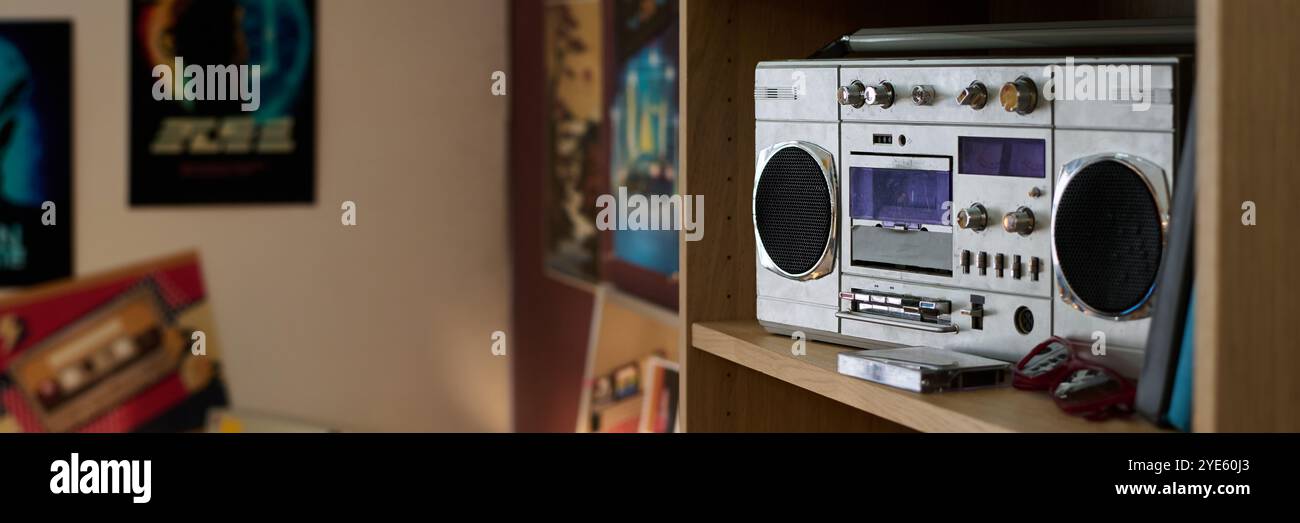 Old-school boombox displayed prominently on a wooden shelf with various ...