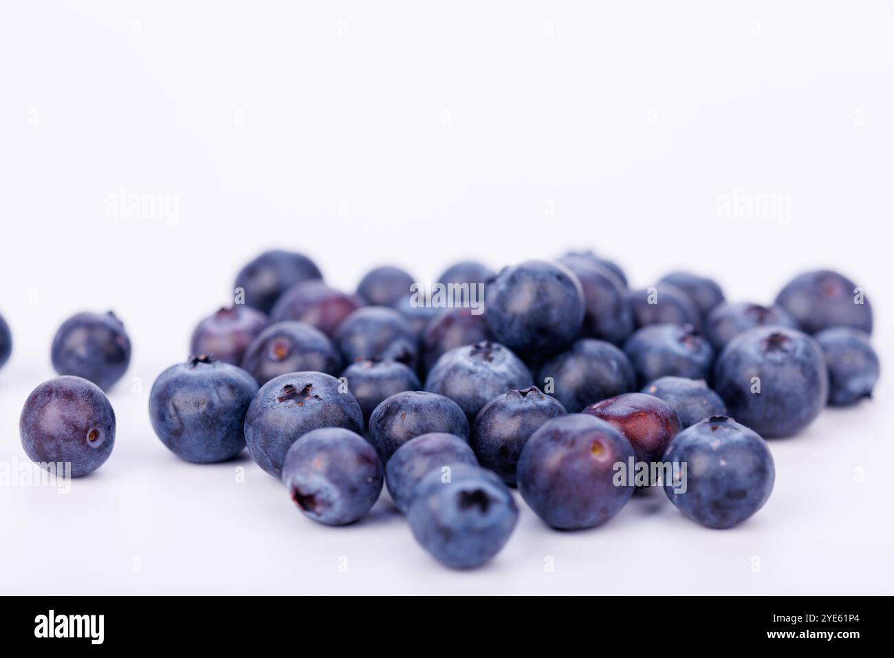A close-up image of a mound of blueberries against a white backdrop ...