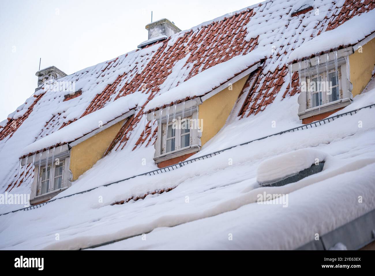 The scene showcases a charming rooftop blanketed in snow, with vibrant ...