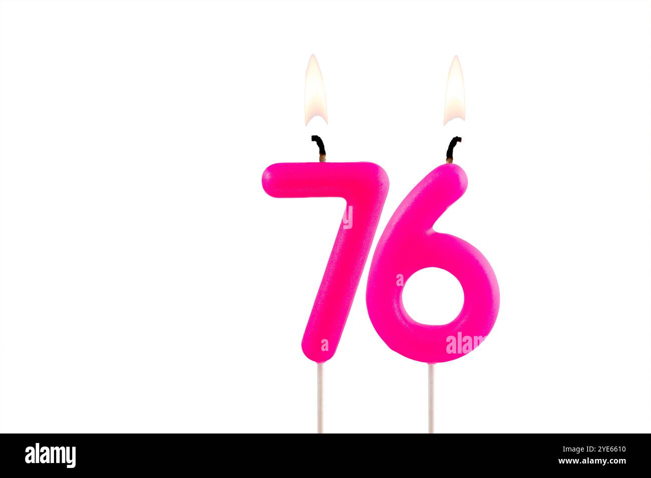 Pink number 76 birthday candle lit on white background Stock Photo - Alamy