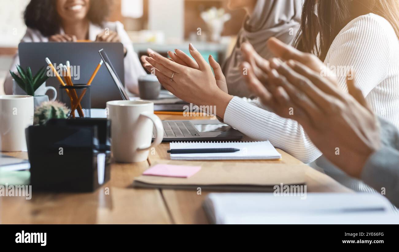 Cropped of multiethnic team of employees clapping hands Stock Photo - Alamy