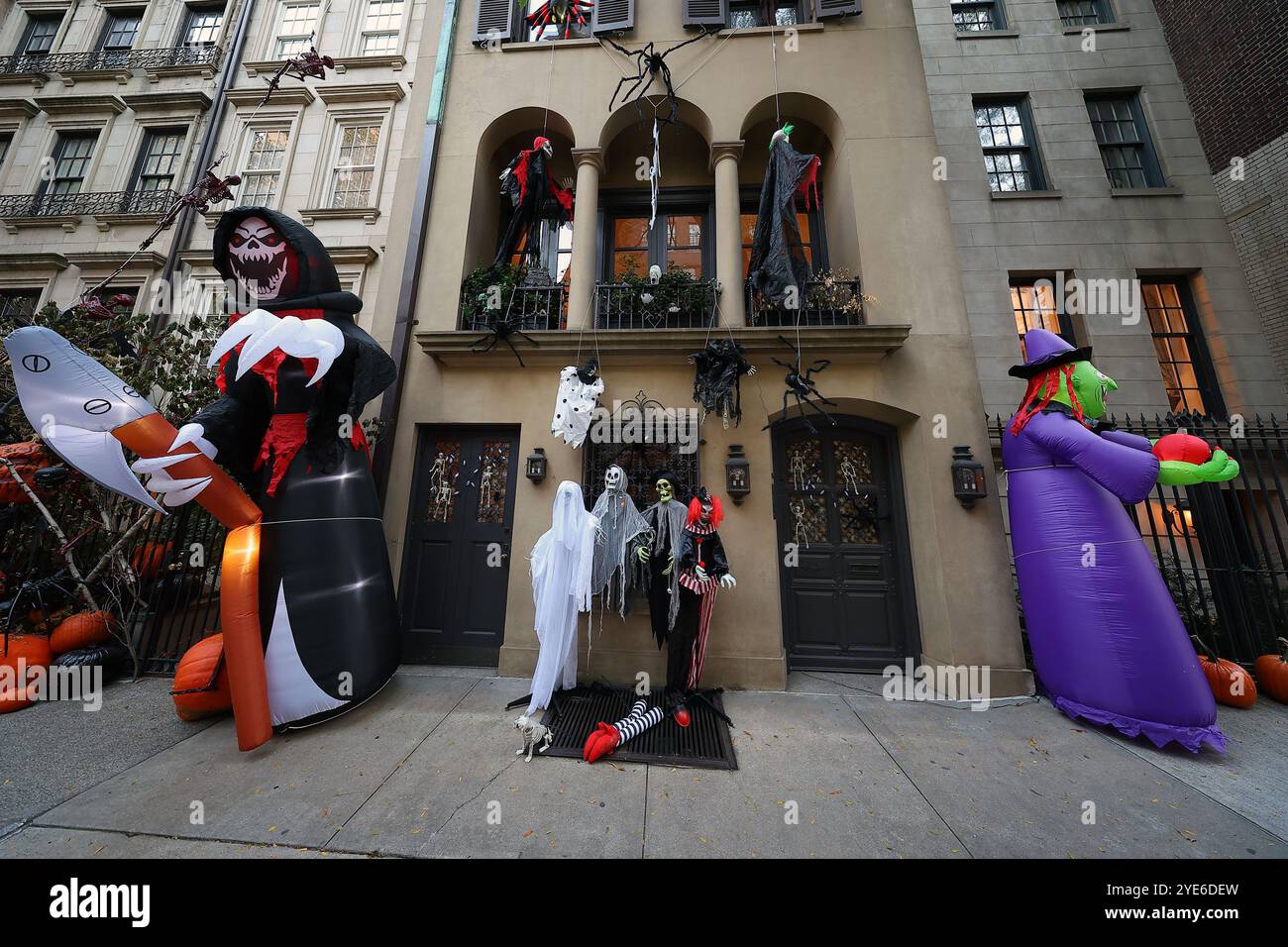 Inflatable creature and a witch, hanging creatures outside an old ...