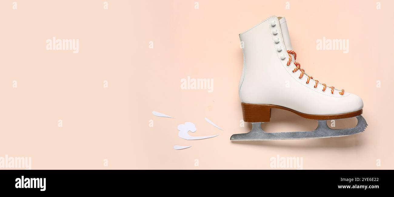 Ice skate on beige background with space for text Stock Photo - Alamy