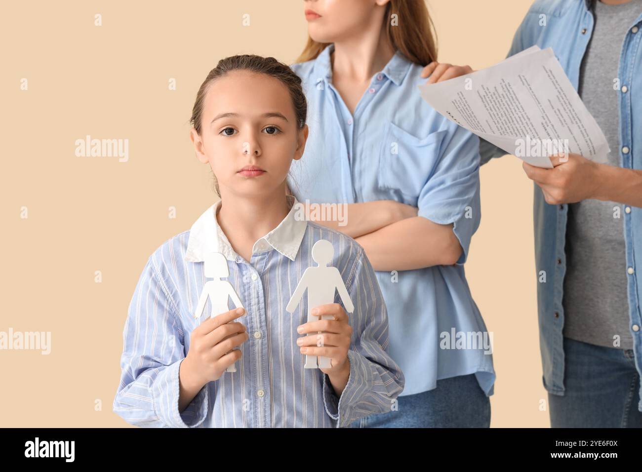 Sad little girl with family figure and her divorced parents on beige ...