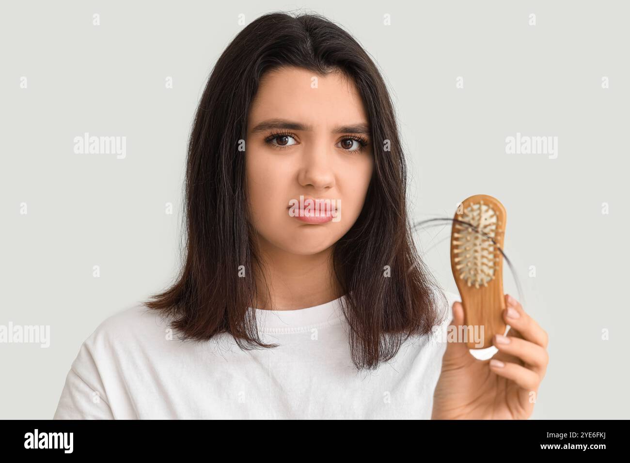Worried young woman with hair loss problem on white background Stock ...