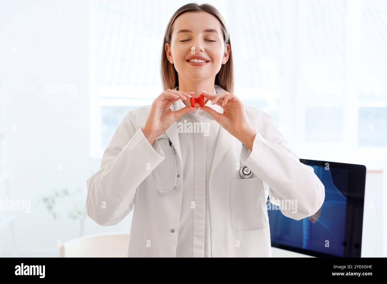 Female endocrinologist with thyroid gland model in clinic Stock Photo ...