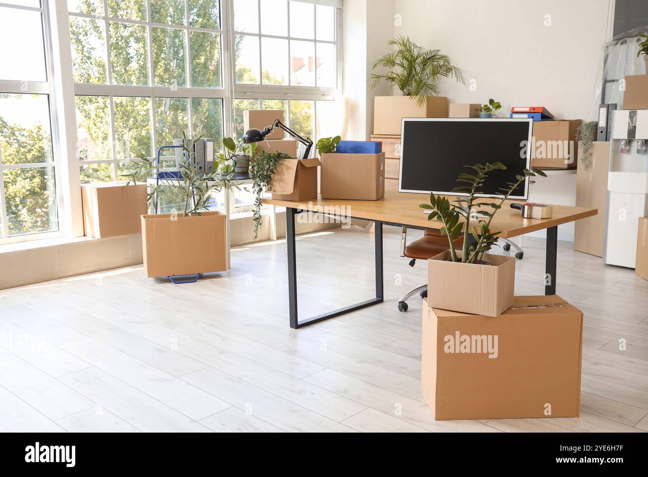 Workplace with computer monitor and boxes in office on moving day Stock ...
