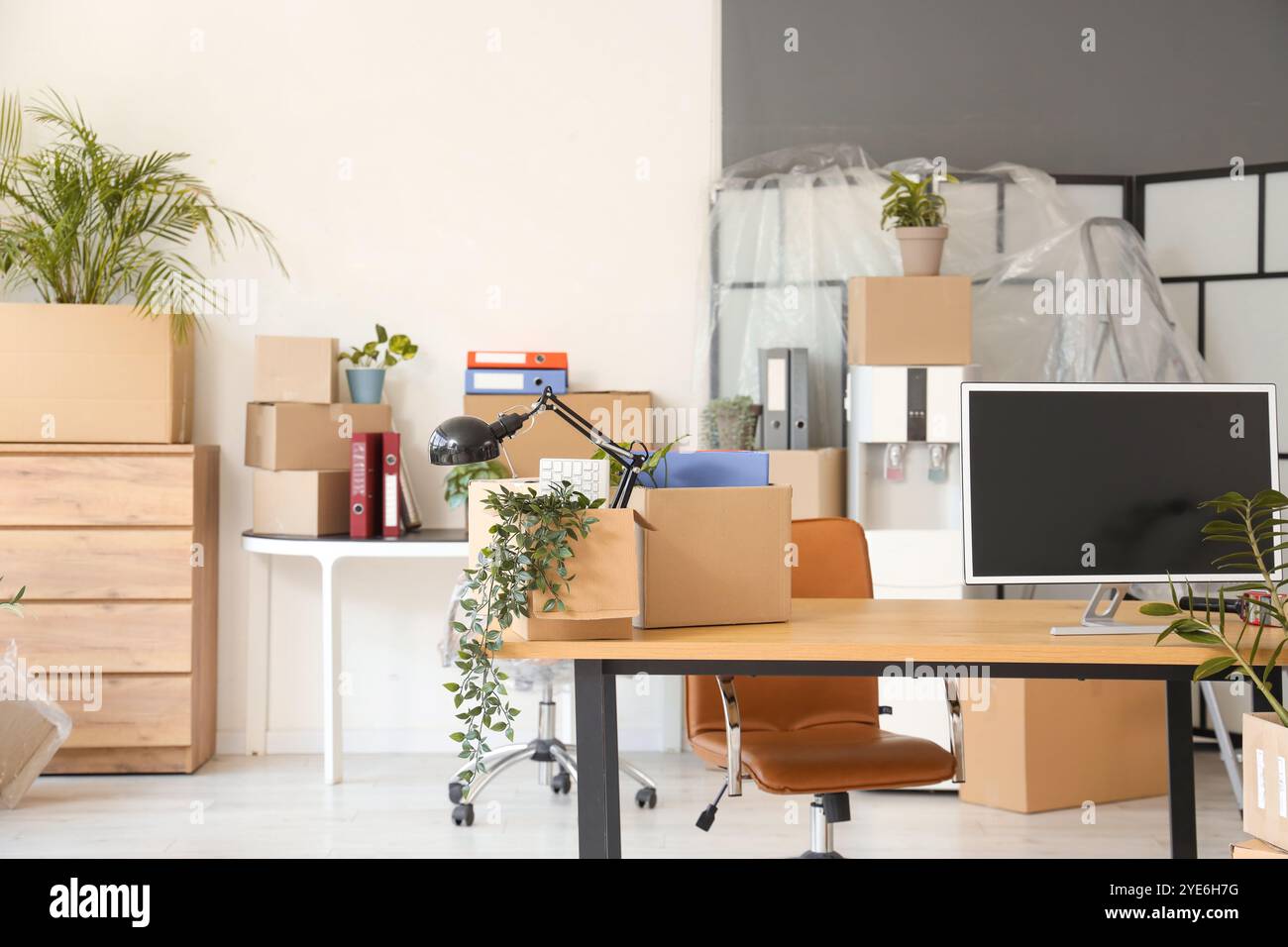 Workplace with computer monitor and boxes in office on moving day Stock ...