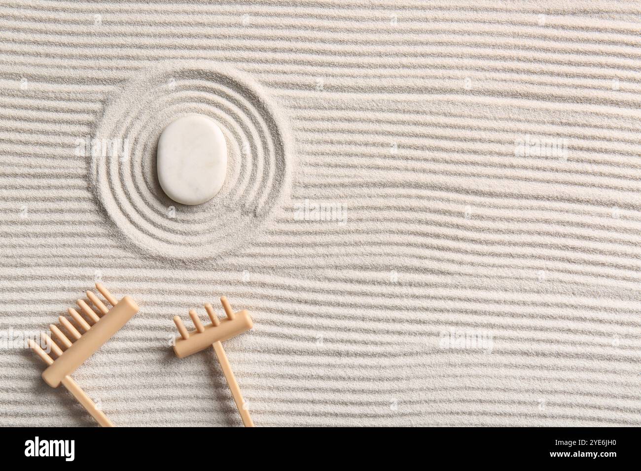 Stone and small rakes on light sand with lines. Zen concept Stock Photo ...