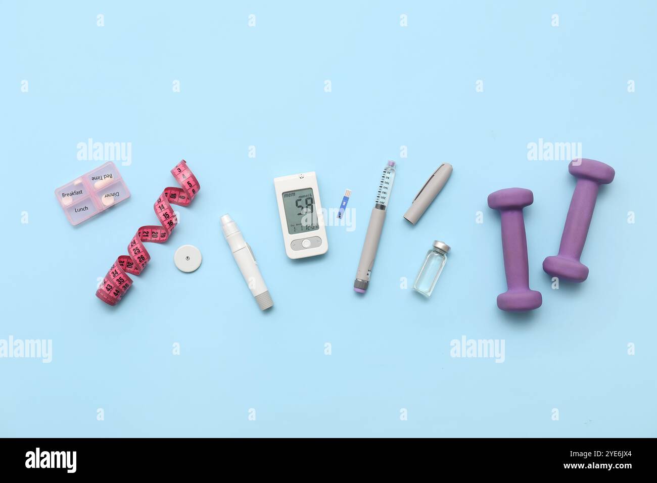 Glucometer with lancet pens, insulin and dumbbells on blue background ...