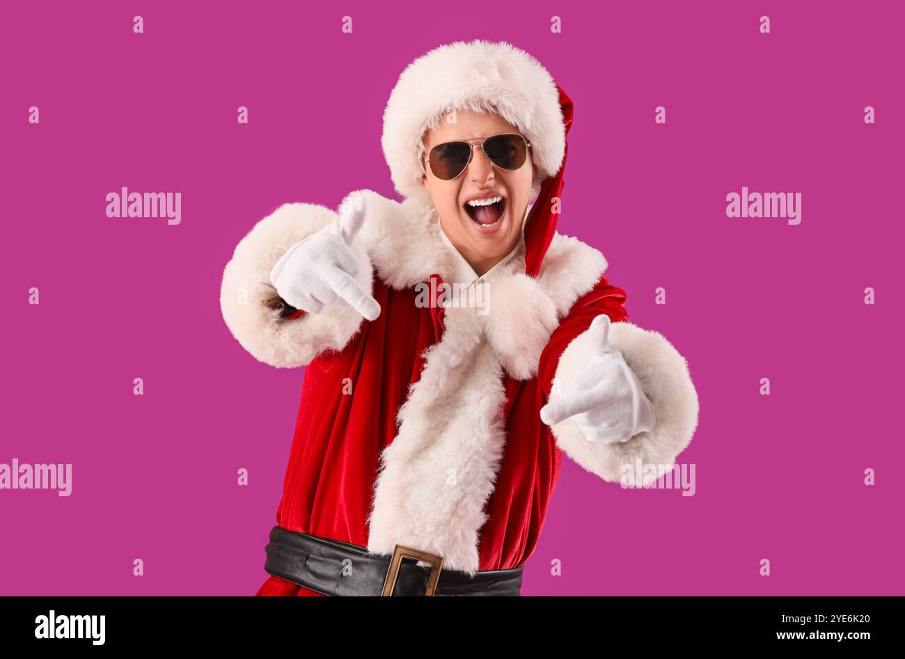 Bad Santa Claus showing middle fingers on violet background Stock Photo ...