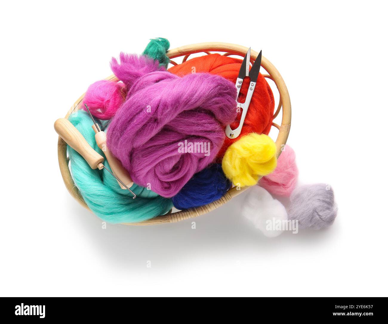 Basket with different wool for felting, thread cutter and needles on ...
