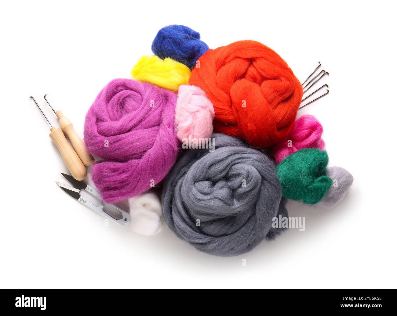 Heap of different wool for felting, needles and thread cutter isolated ...