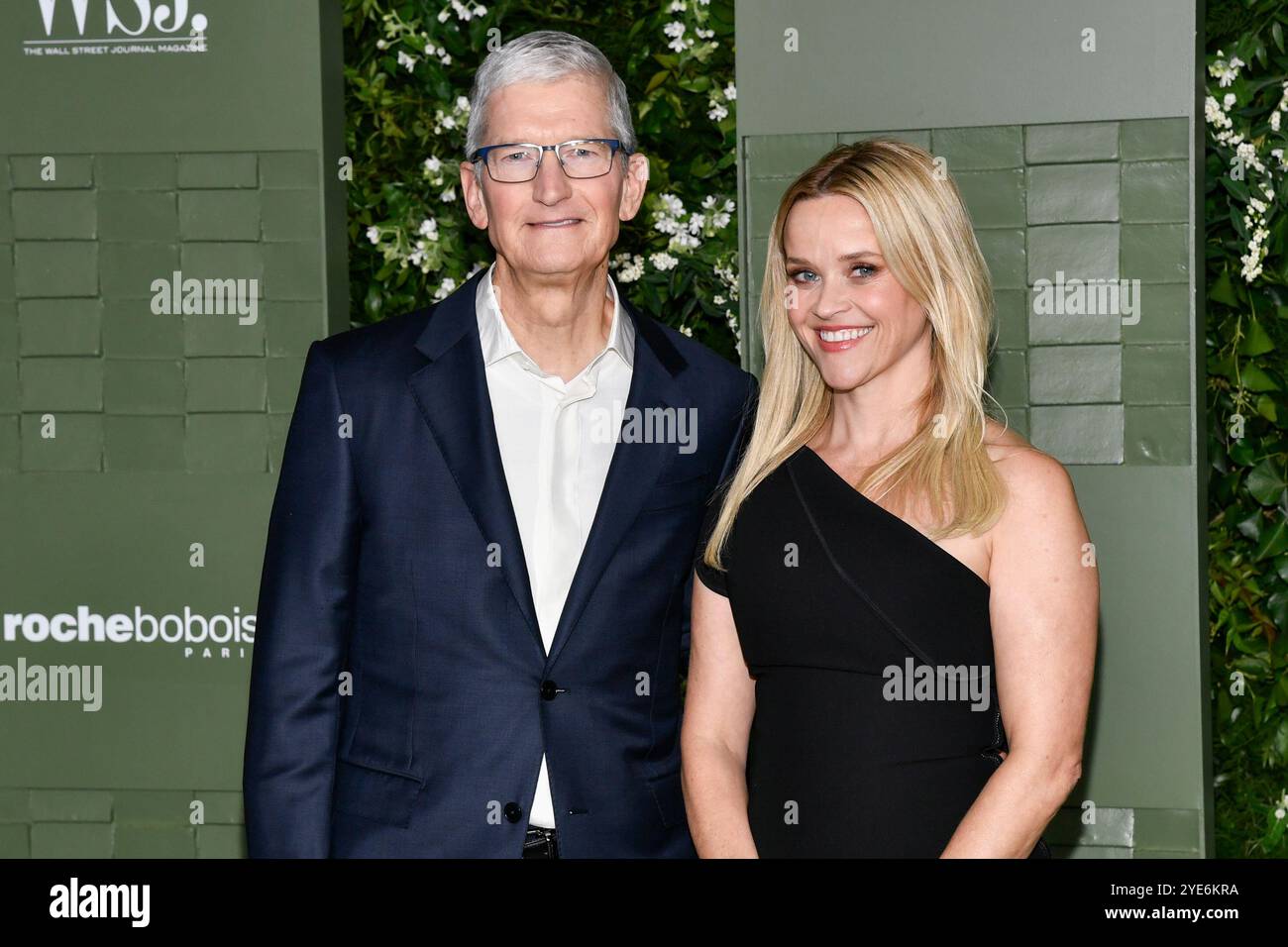 Tim Cook, left, and Reese Witherspoon attend the WSJ. Magazine ...