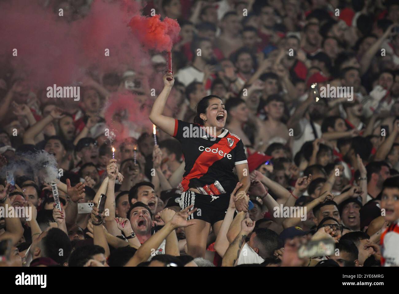 Fans of Argentina's River Plate cheer and light flares as they wait for ...