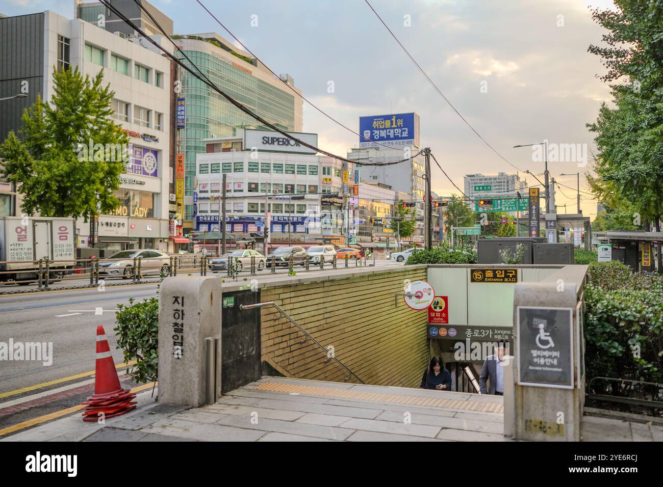 Man is walking down a subway entrance. The sign is in a foreign ...