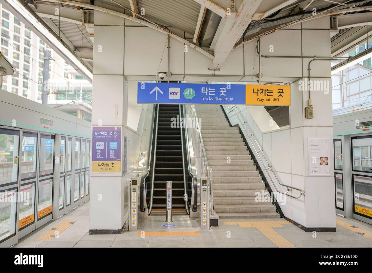 Train station with a blue sign that says "ATM" on it. There is a ...