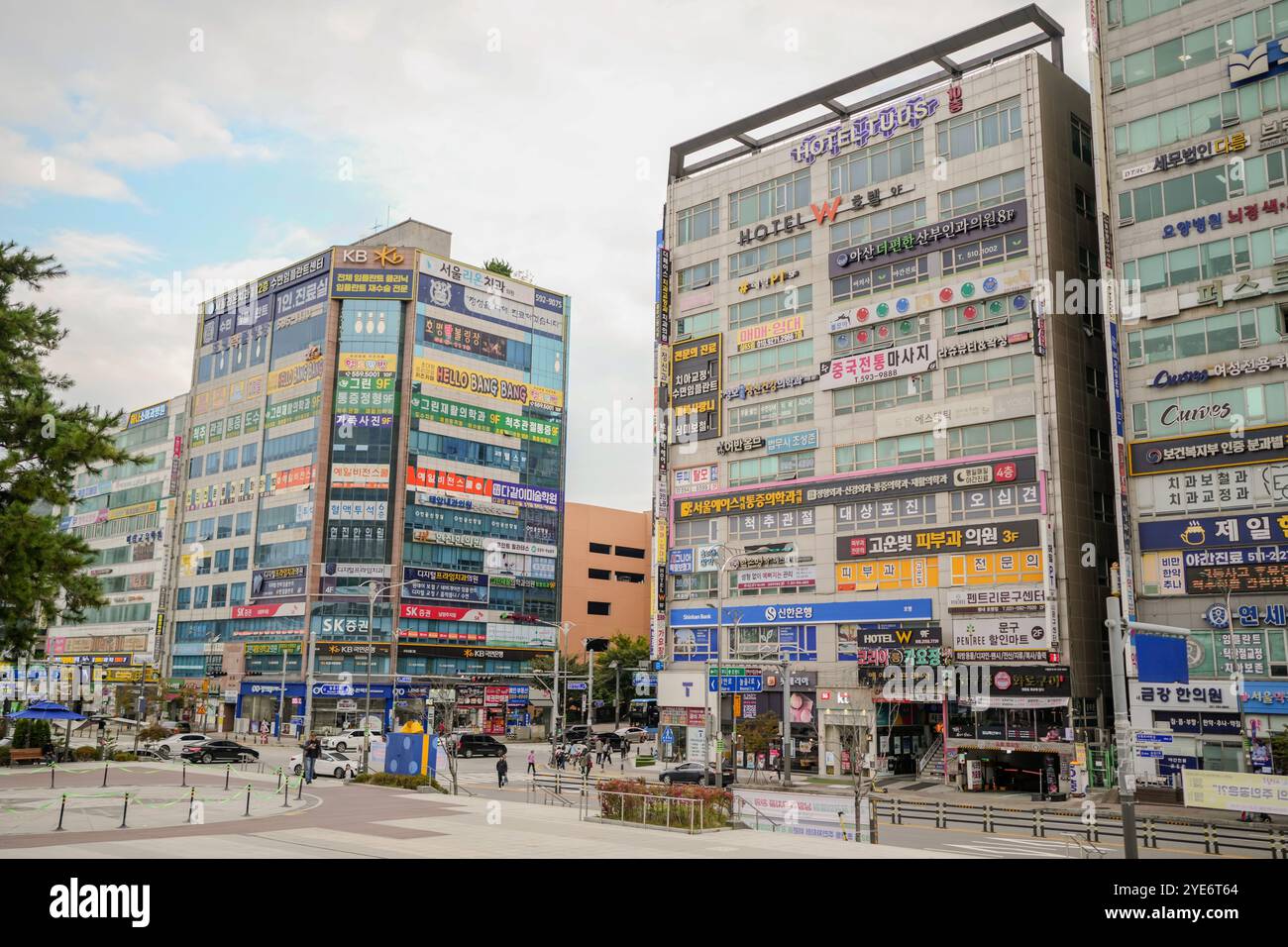 Busy city street with many tall buildings and a lot of people walking ...