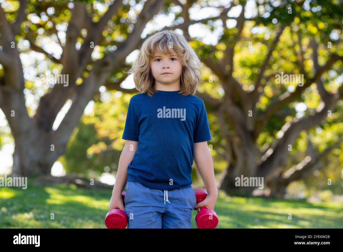 Kids sport training in summer park outdoor. Sport activities at leisure with children. Blonde ...