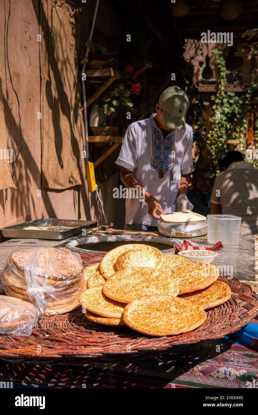 A man making some traditional Silk road bread in Kashgar, Xinjiang ...