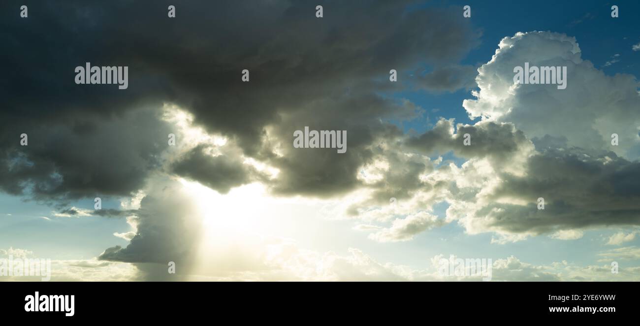 Beautiful sunset sky with clouds. Sky blue and orange light of the sun through the clouds in sky ...