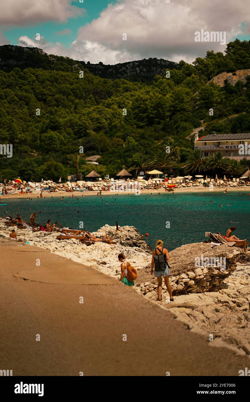 People Relaxing on the beach taken at Kova Beach, Pokonji dol bay ...