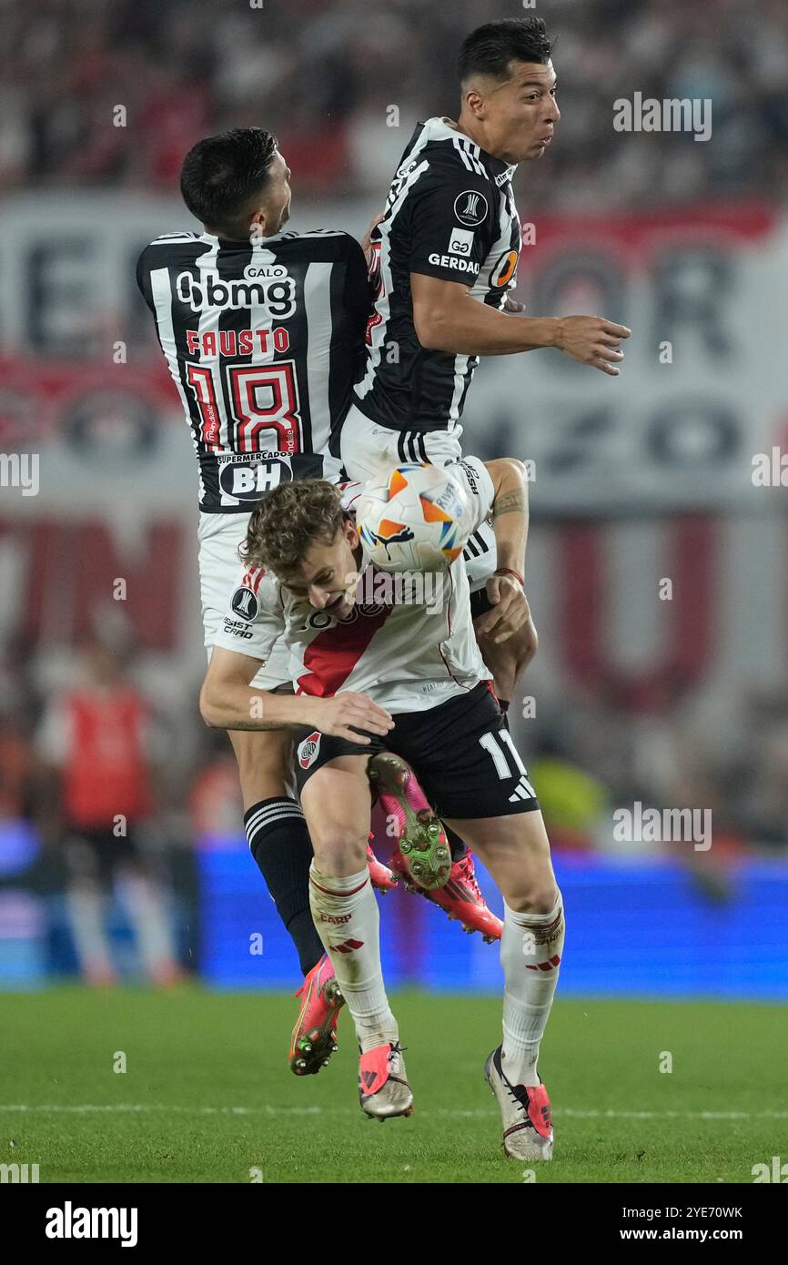 Facundo Colidio of Argentina's River Plate, center, battles for the ball with Fausto Vera, left ...