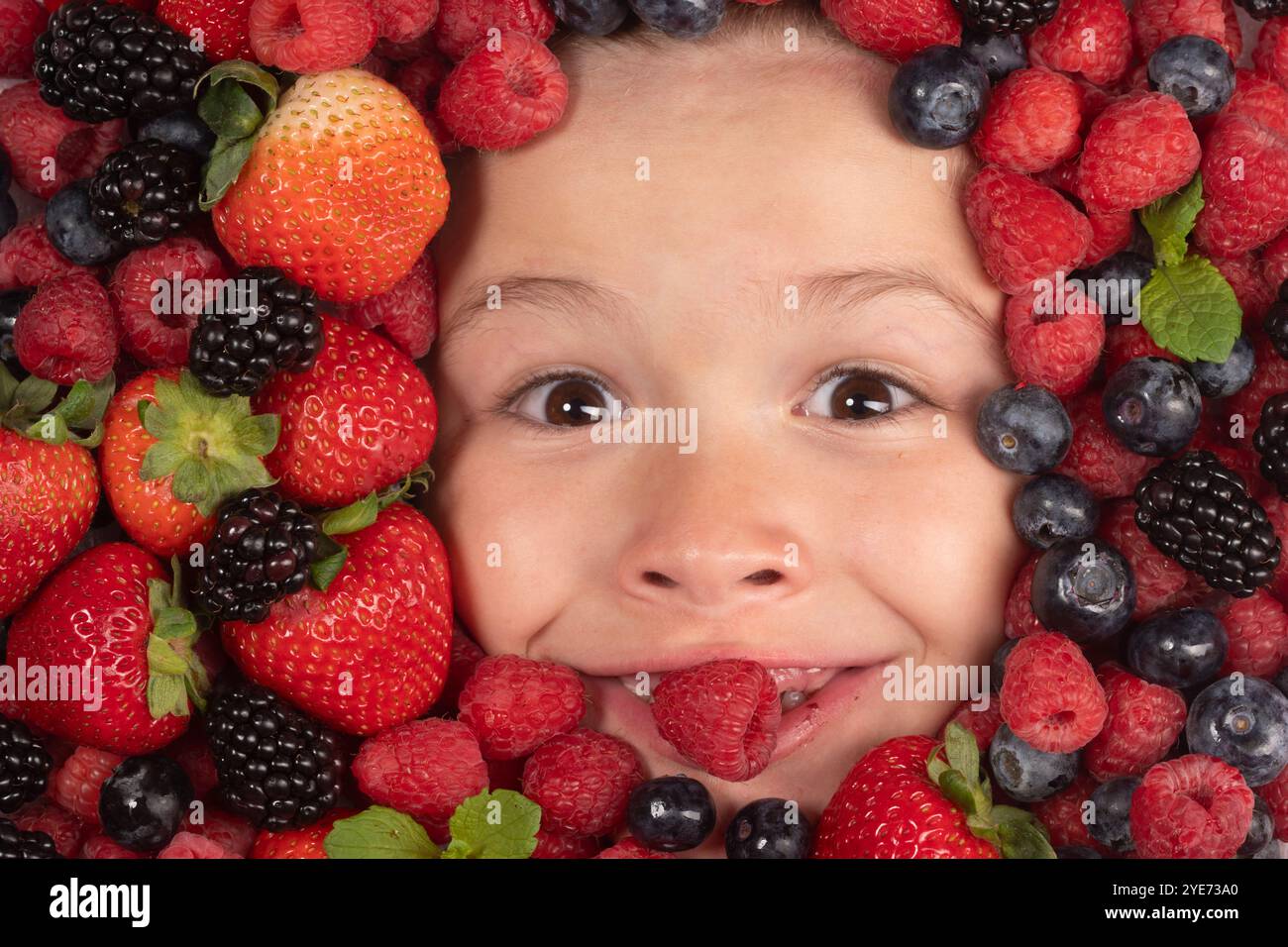 Berrie set. Berries child face close up. Top view photo of child face ...