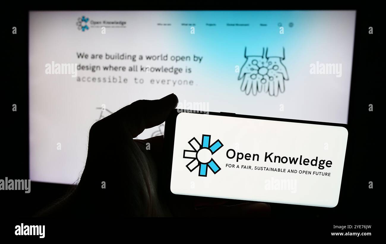 Germany. 25th June, 2024. In this photo illustration, a man is holding a smartphone with the ...