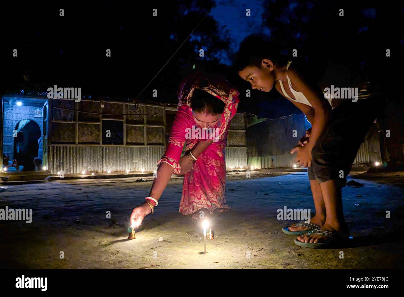 FENI, BANGLADESH - OCTOBER 17: Mother and child playing with light ...