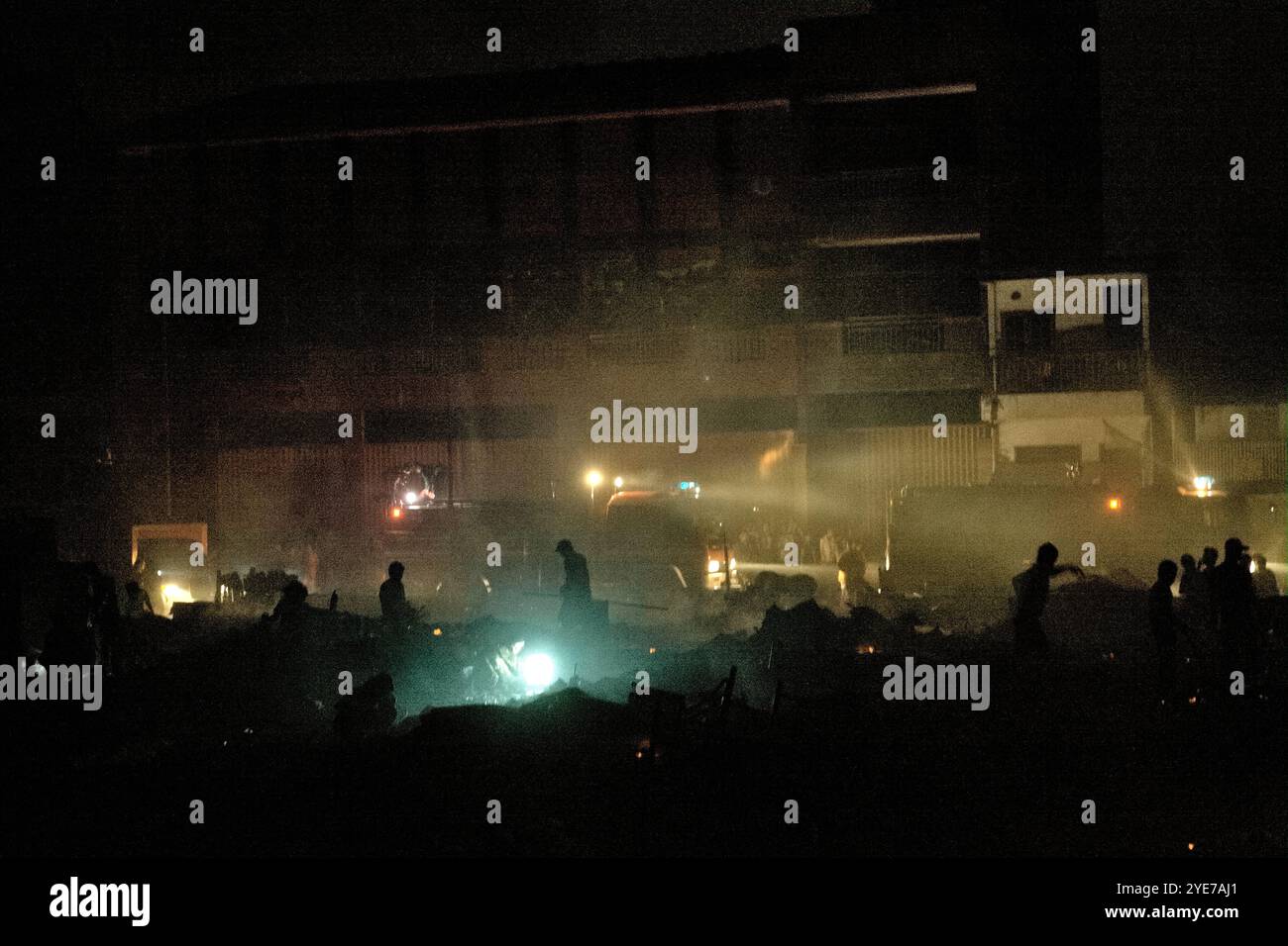 Scene of a dense neighborhood location where fire brigade and residents ...