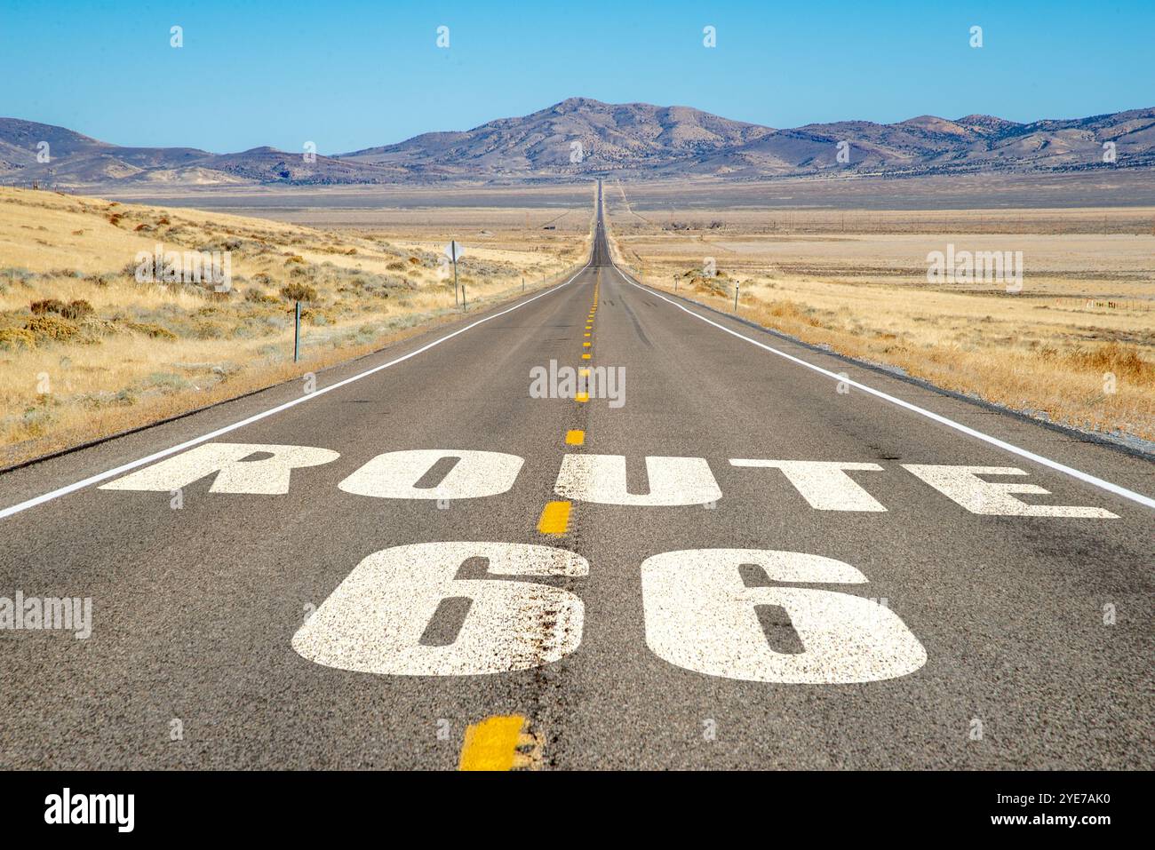 Long, straight section of highway in the desert Southwest with ROUTE 66 ...
