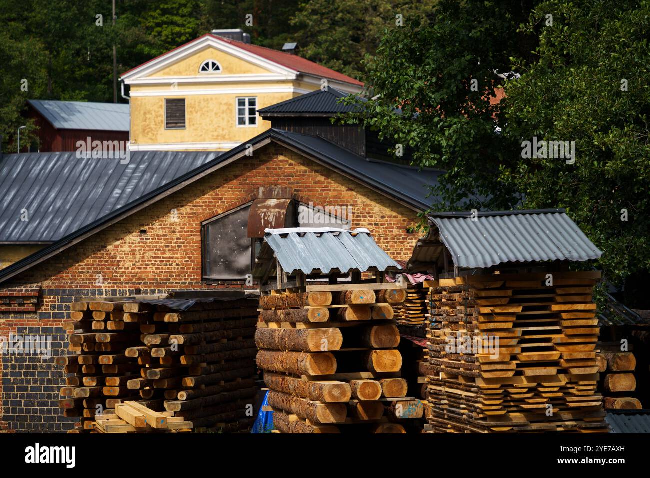 Stacks of timber and lumber outside historic saw mill in summer Stock ...